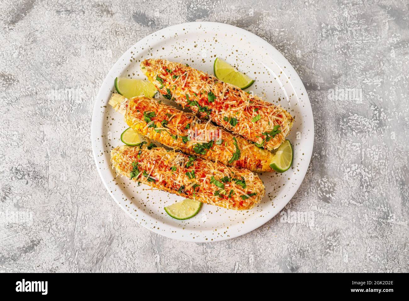 Plate with tasty Elote Mexican Street Corn on grunge background Stock ...