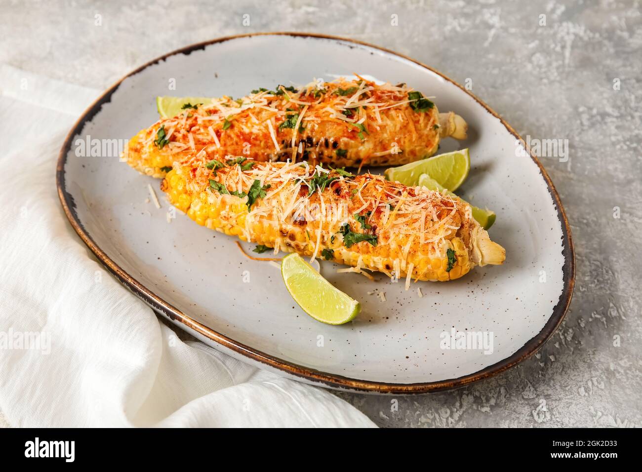 Plate with tasty Elote Mexican Street Corn on grey background Stock ...
