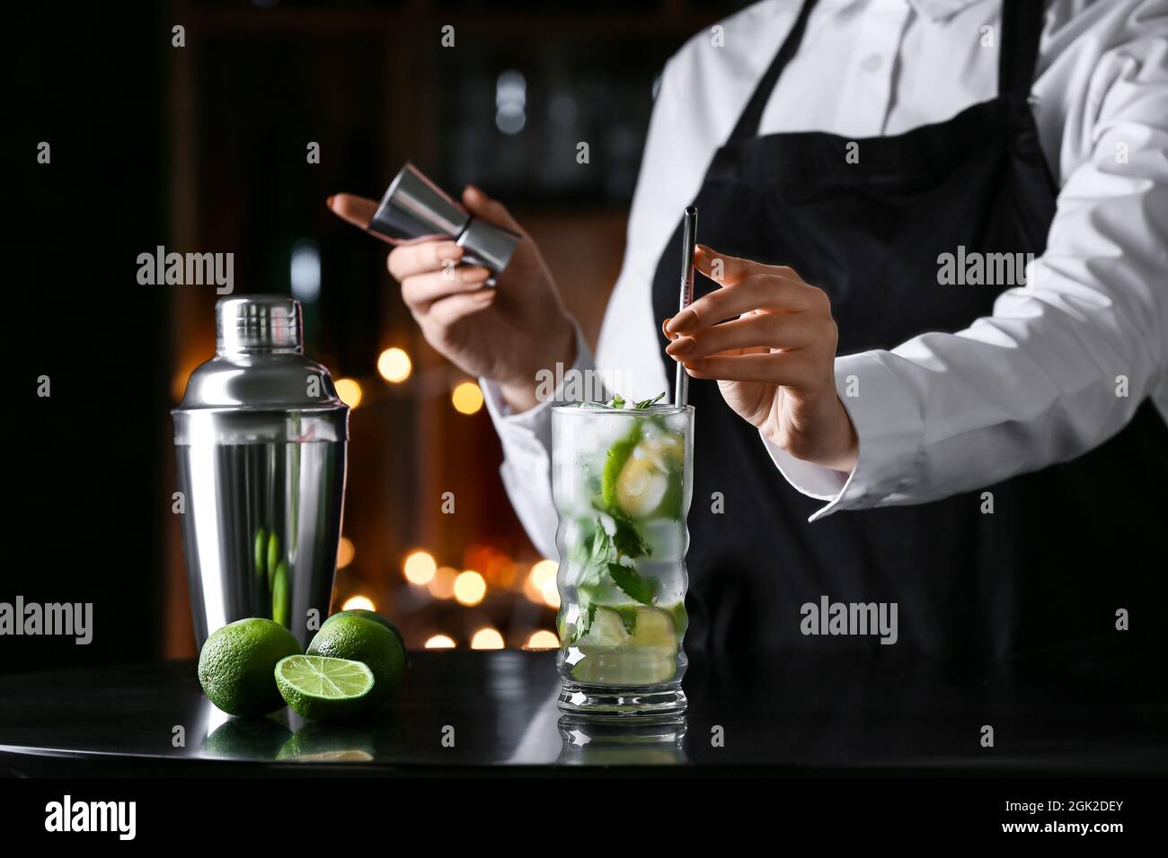 Female bartender making tasty mojito on table in bar Stock Photo - Alamy