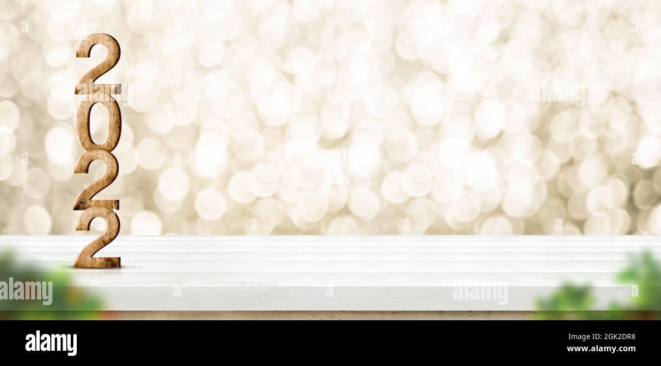 2022 happy new year wood number (3d rendering) on white wood table with sparkling gold bokeh ...
