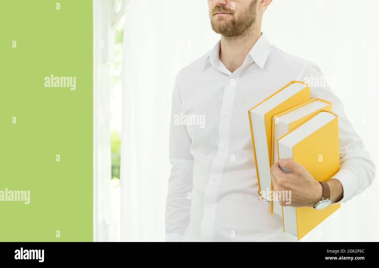 Young nerd student collage holding stack of book. Student life try to ...