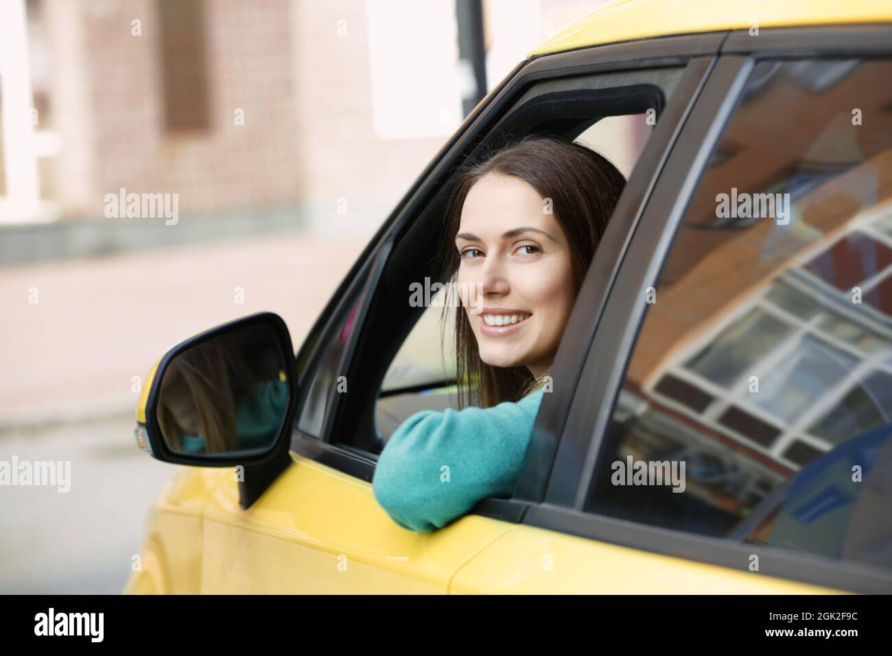 Female taxi driver sitting in yellow car Stock Photo - Alamy