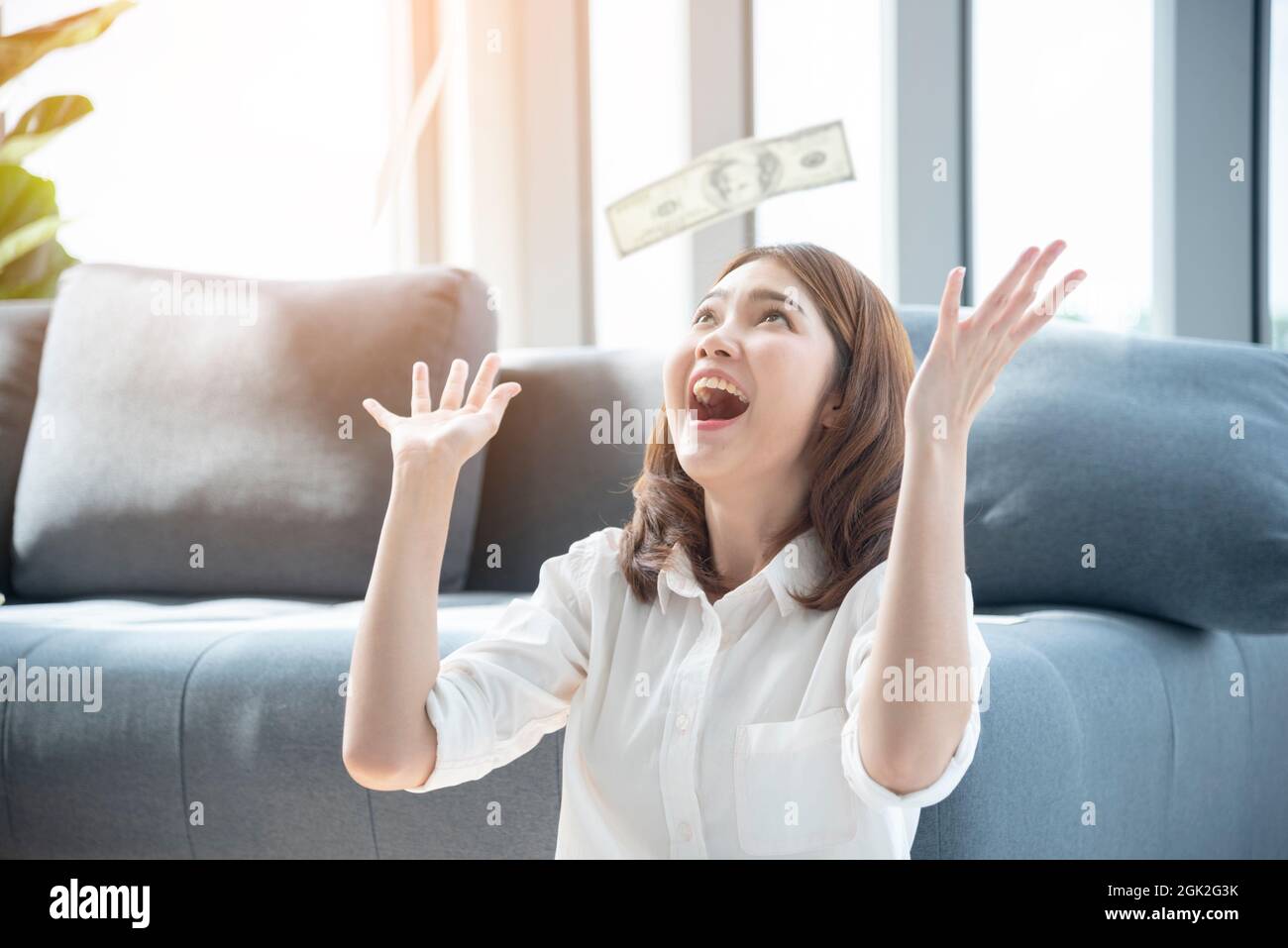 Woman excited with money dollar banknote rain fall. Happy start up ...