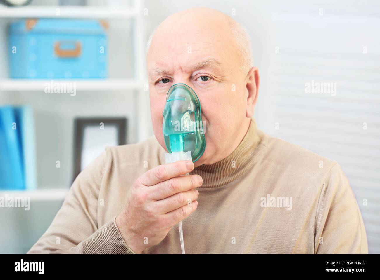 Senior man using asthma machine at home Stock Photo - Alamy