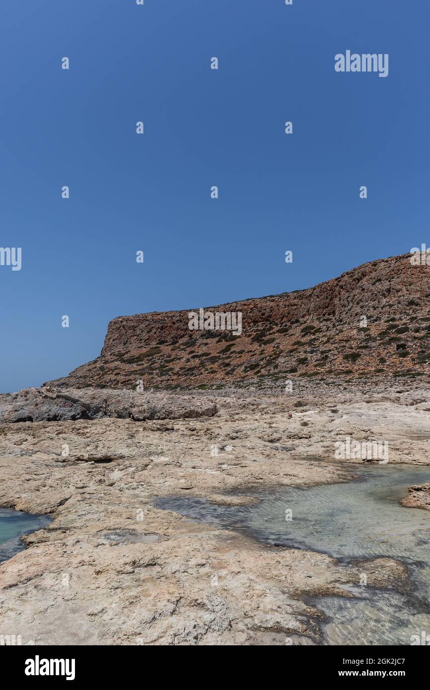 Vertical shot of the stones geological formation on the ocean's beach ...