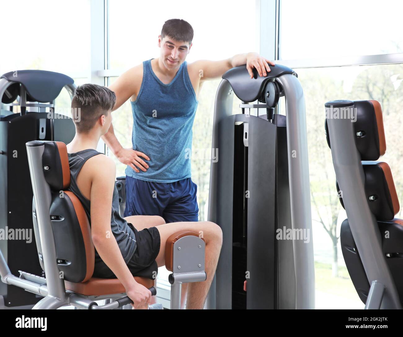 Dad and son training in modern gym Stock Photo - Alamy