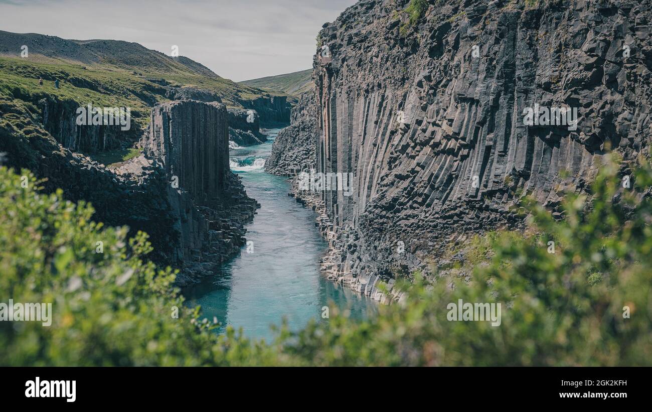 Overview of Studlagil canyon in Iceland, picturesque valley with basalt columns standing high on ...