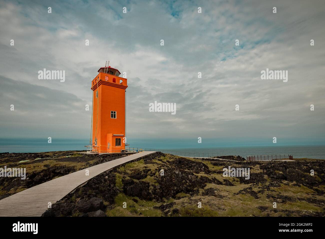 Orange Svörtuloft Lighthouse on western part of Iceland on a colorful ...