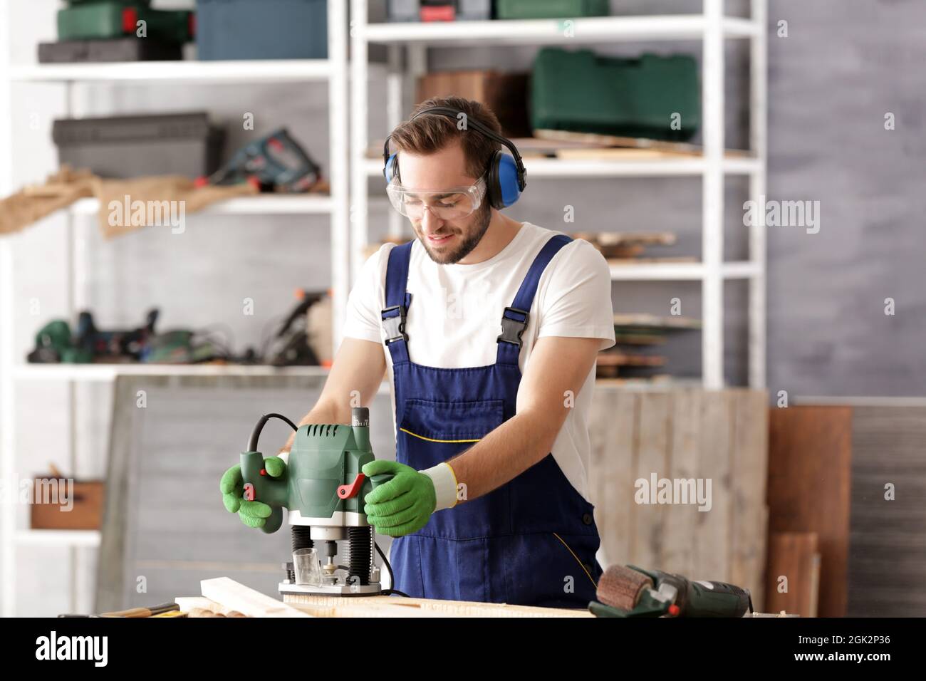 Carpenter working with plunge router in light shop Stock Photo - Alamy