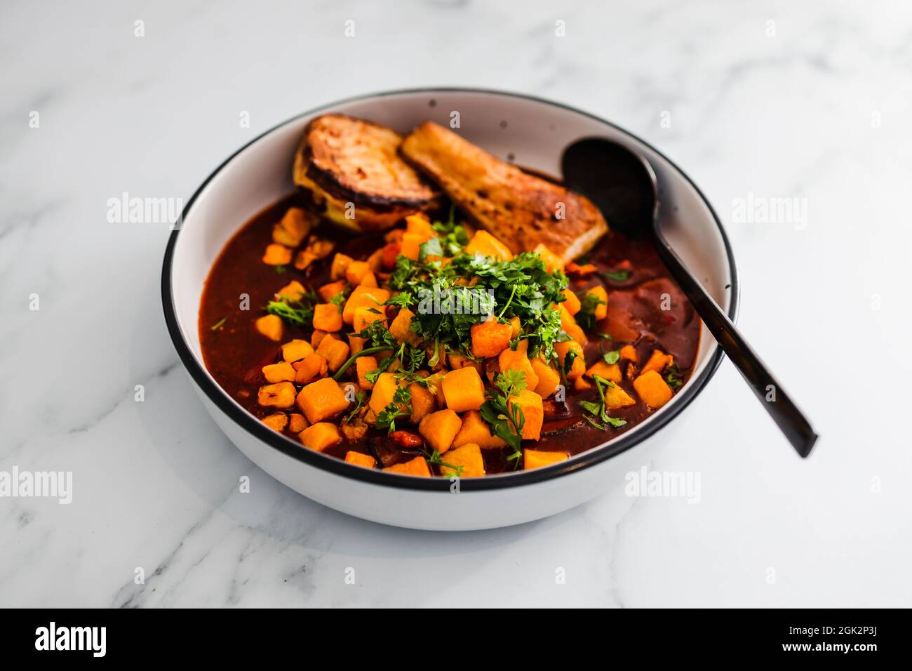 vegan butter chicken curry with pumpkin swede and parsnip topped with ...