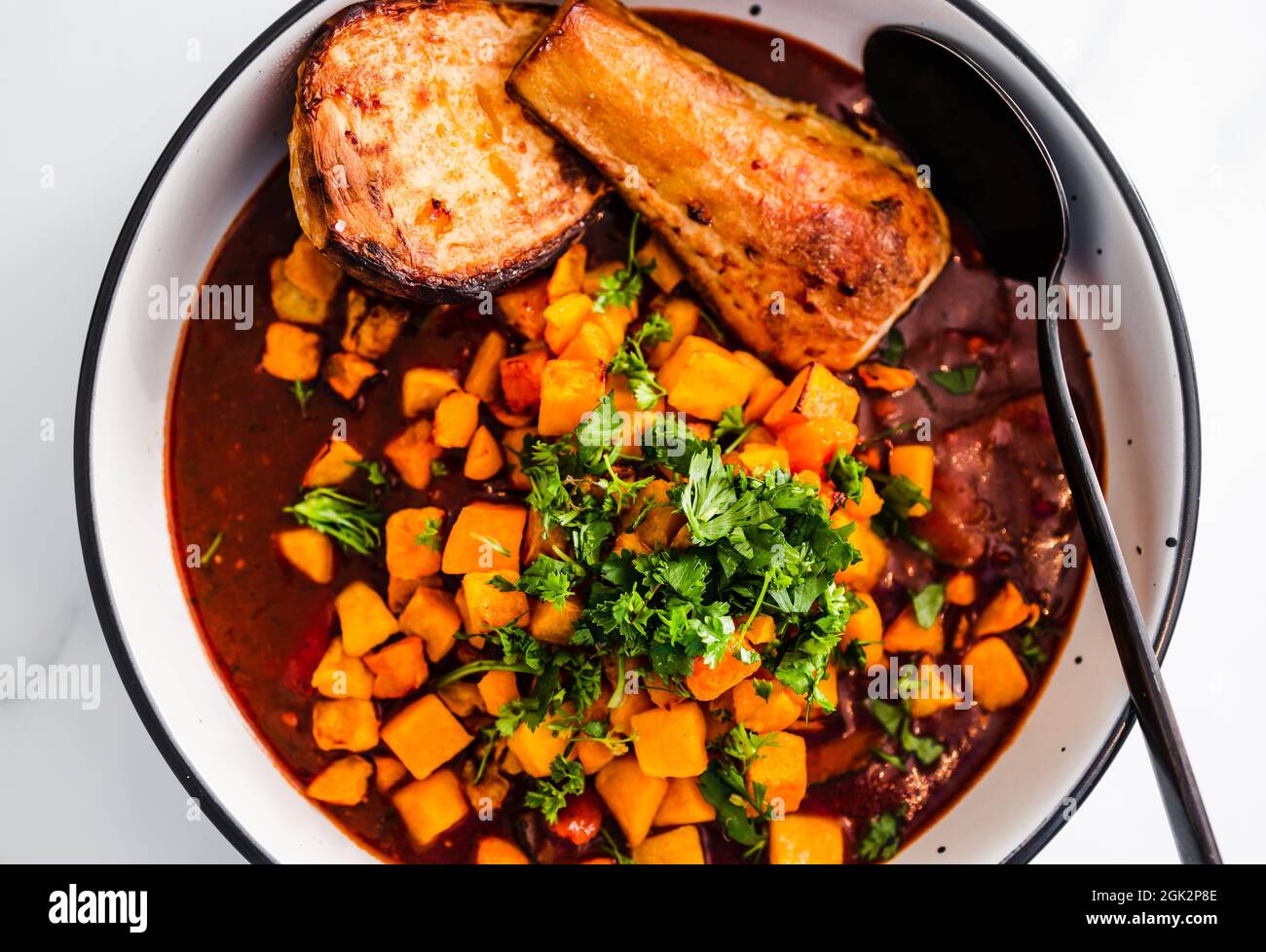 vegan butter chicken curry with pumpkin swede and parsnip topped with ...