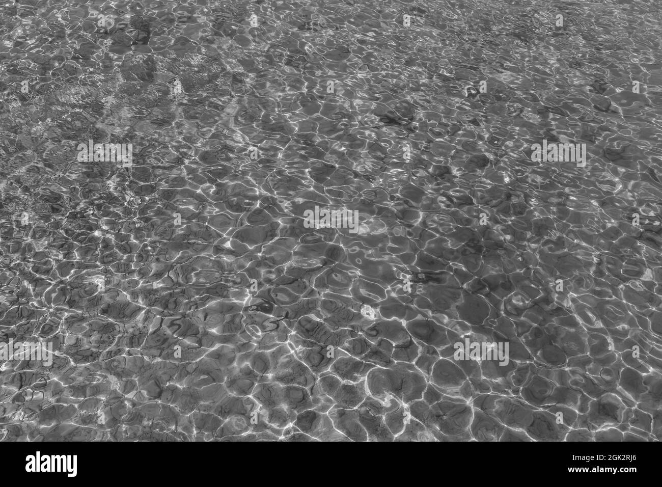 Horizontal view of a clean and clear water of the sea in a black and ...
