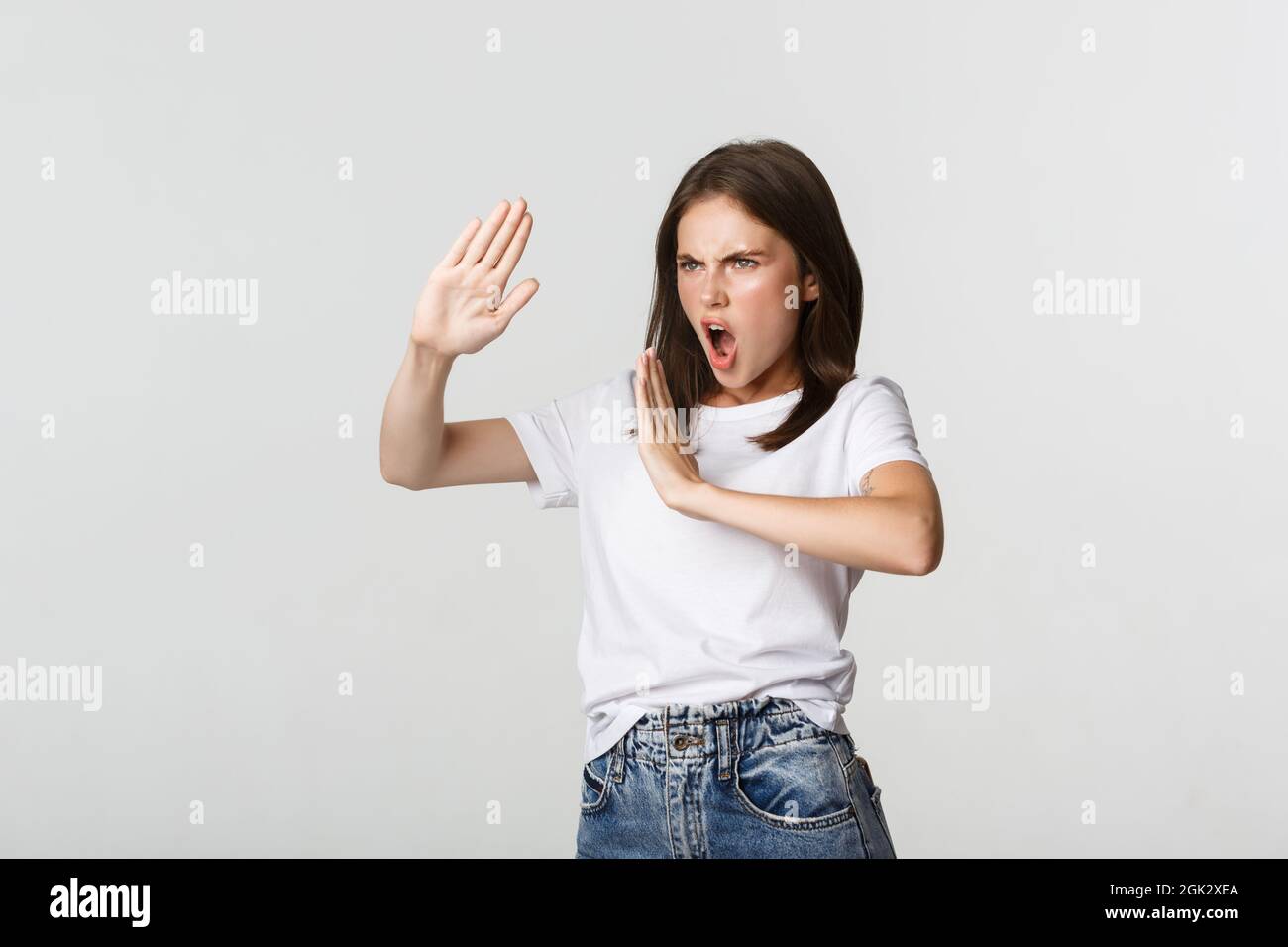 Sassy young woman standing in fighting pose to protect herself from ...