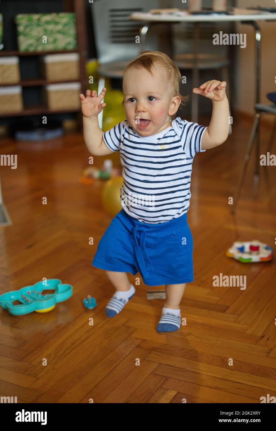 Adorable little baby boy taking his first steps Stock Photo - Alamy