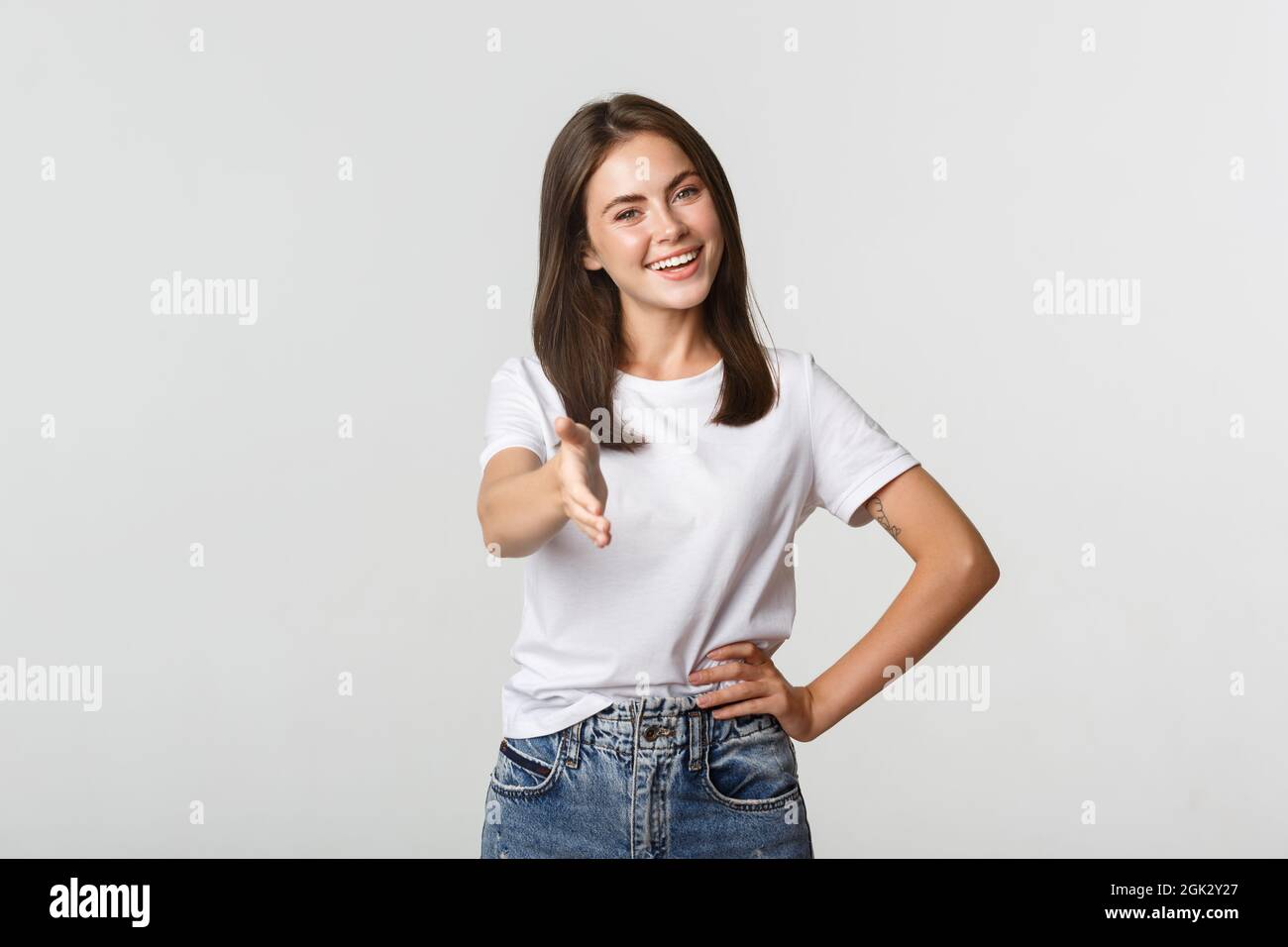 Smiling confident young woman extend hand for handshake, greeting ...