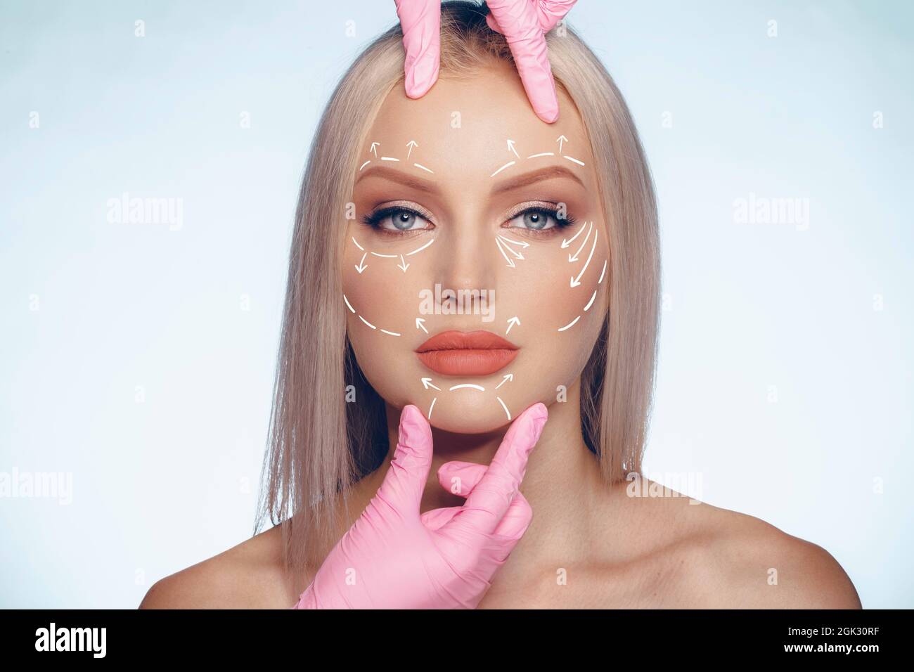 Caucasian beautiful female face marked with arrows on the main facial ...