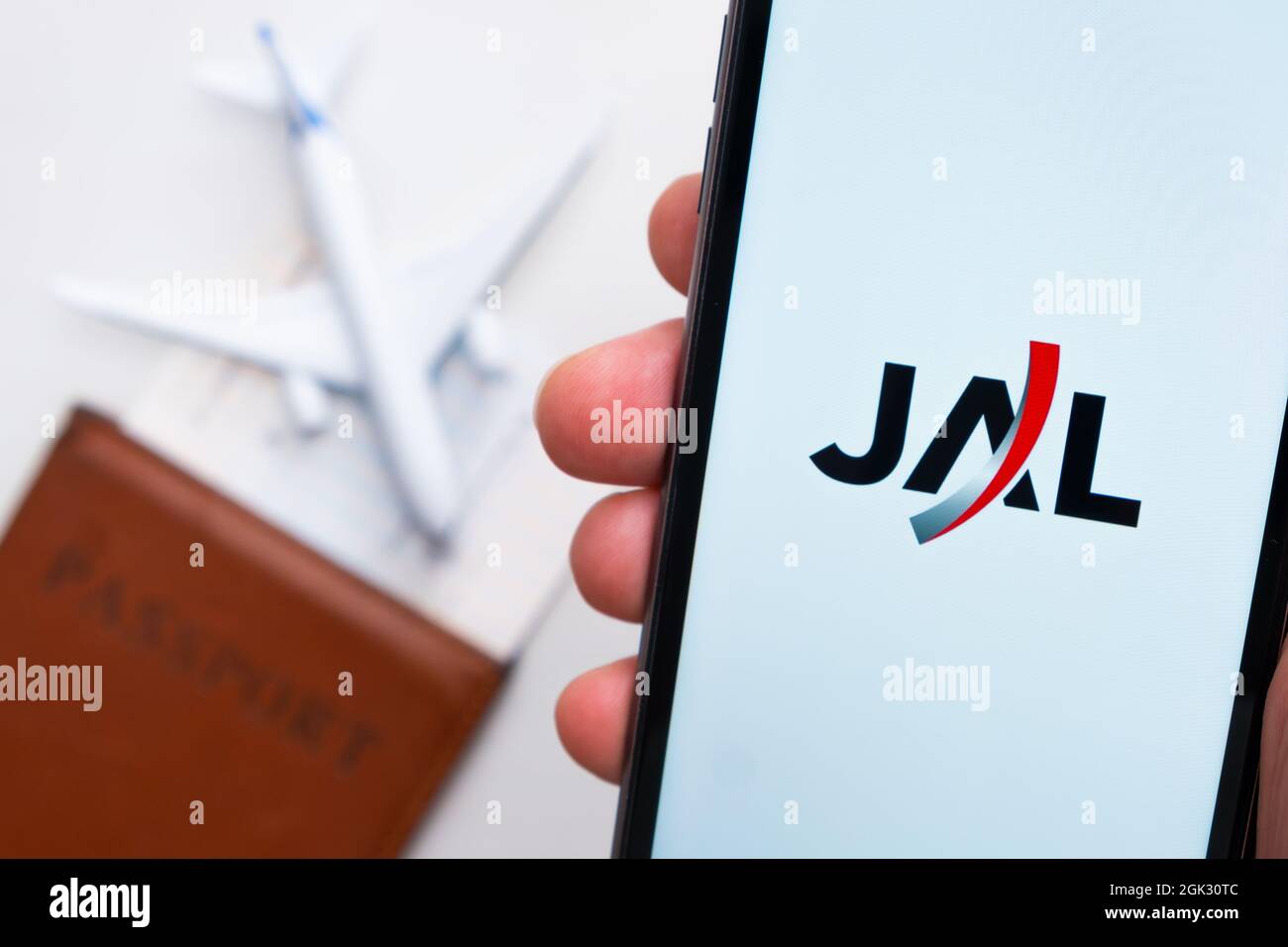 JAL airline company app or logo displayed on a mobile phone with ...