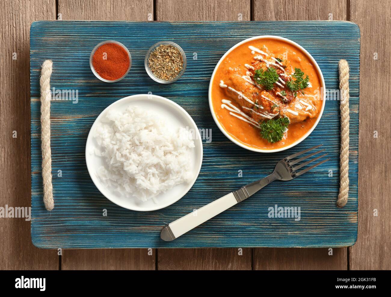 Plate with delicious Murgh Makhani and rice on table Stock Photo - Alamy