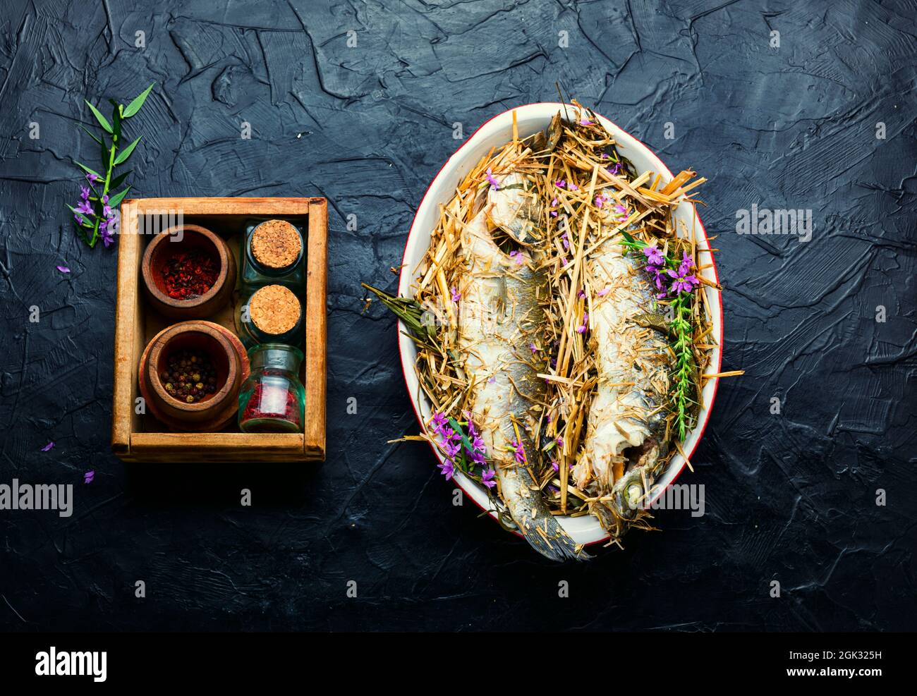 Fish baked in herbs and meadow hay. Roasted sea bass with spicy herbs ...