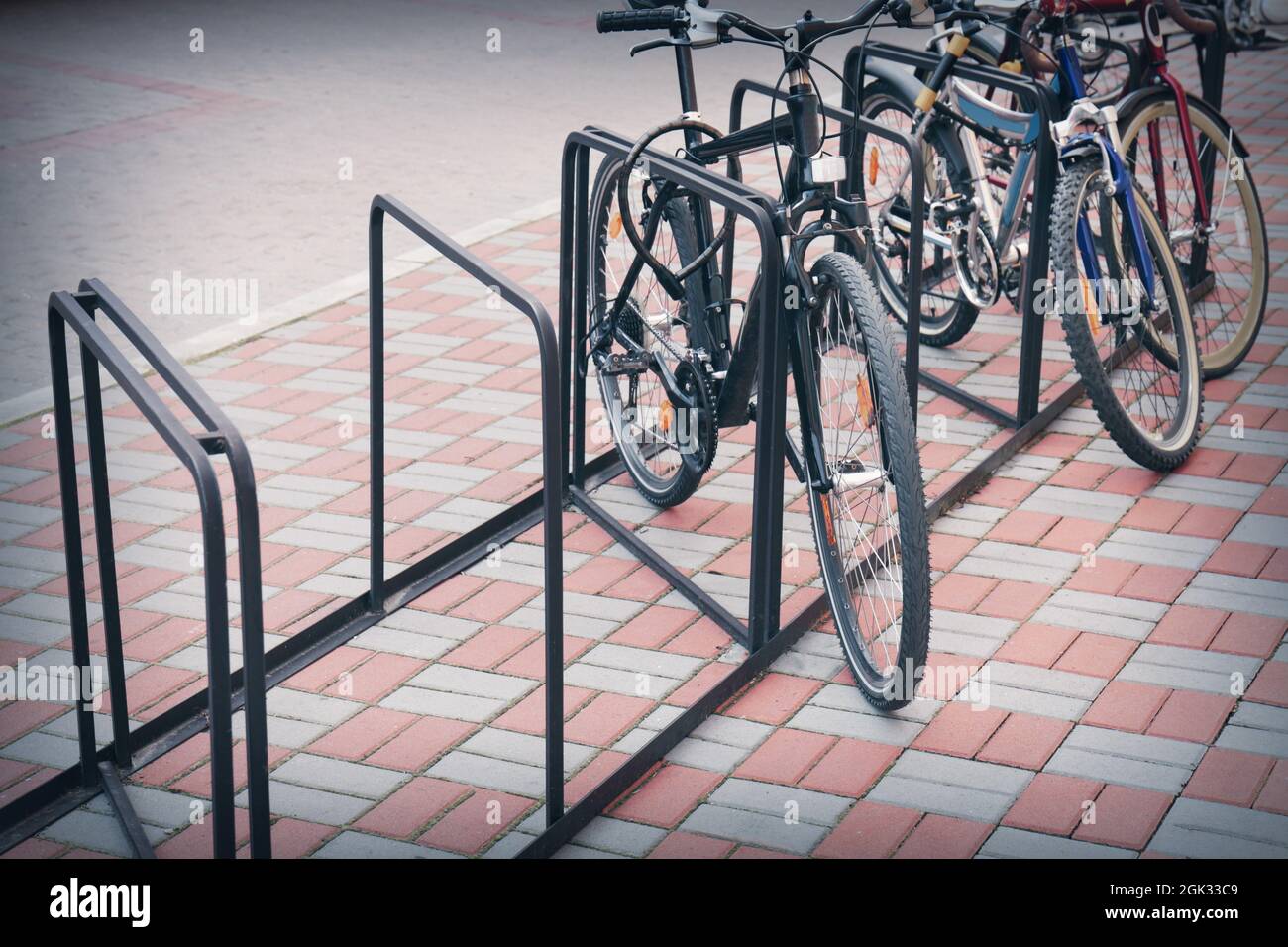 Bicycle rack with bikes on sidewalk Stock Photo - Alamy