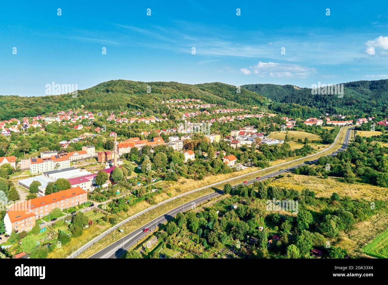 Village near mountain and agricultural fields at sunset. Nature ...