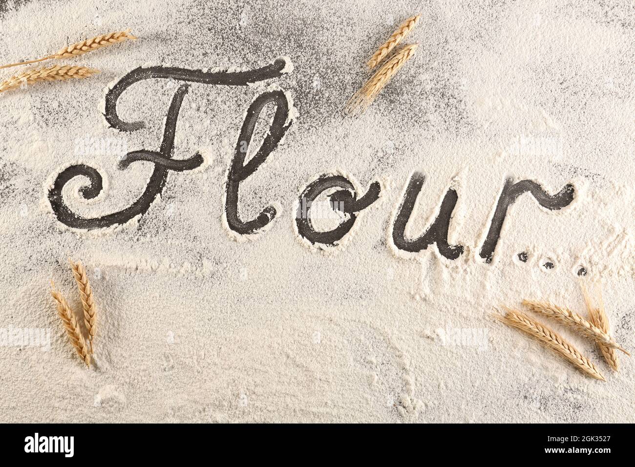 Word written on wheat flour, closeup Stock Photo - Alamy