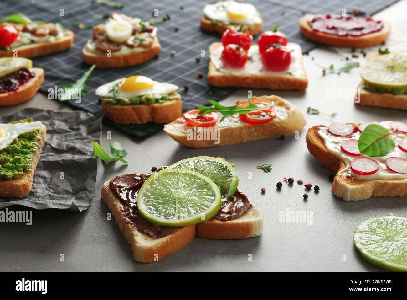 Different tasty breakfast toasts on table Stock Photo - Alamy