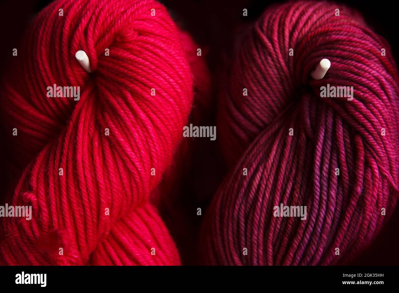 Two skeins of red yarn in the shop. Background of the different woolen ...