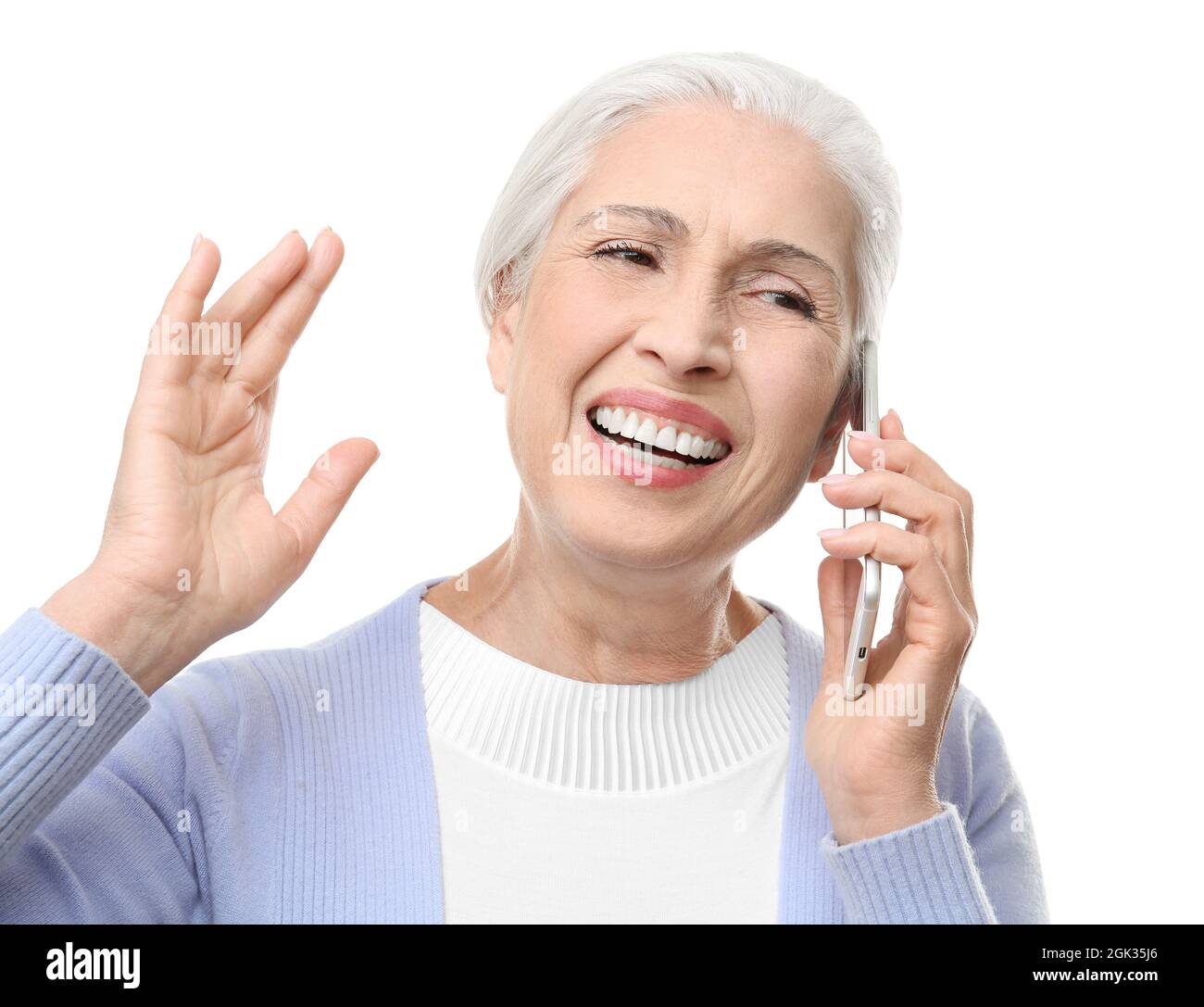 Beautiful elegant elderly woman talking on mobile phone against white ...