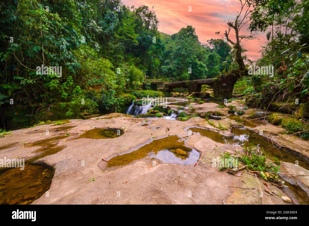 A stone bridge over a mountain stream on the way to the Krang Shuri or ...