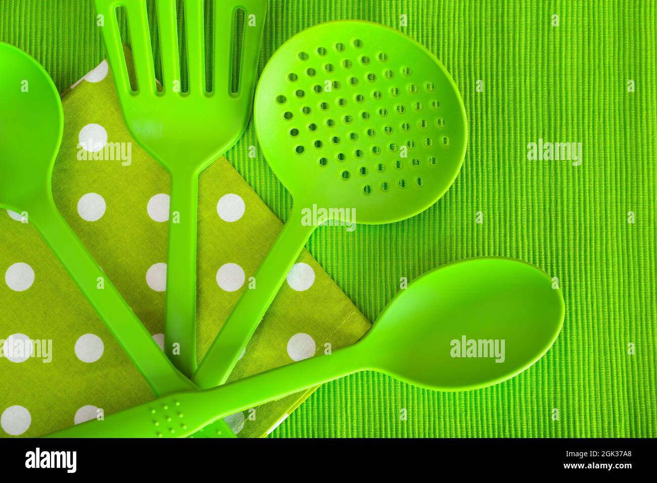 Green utensils on textured background Stock Photo - Alamy