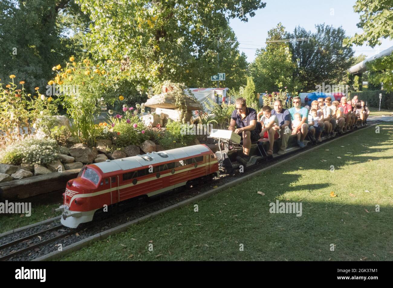 Budapest. 12th Sep, 2021. People ride on miniature train carriages at ...
