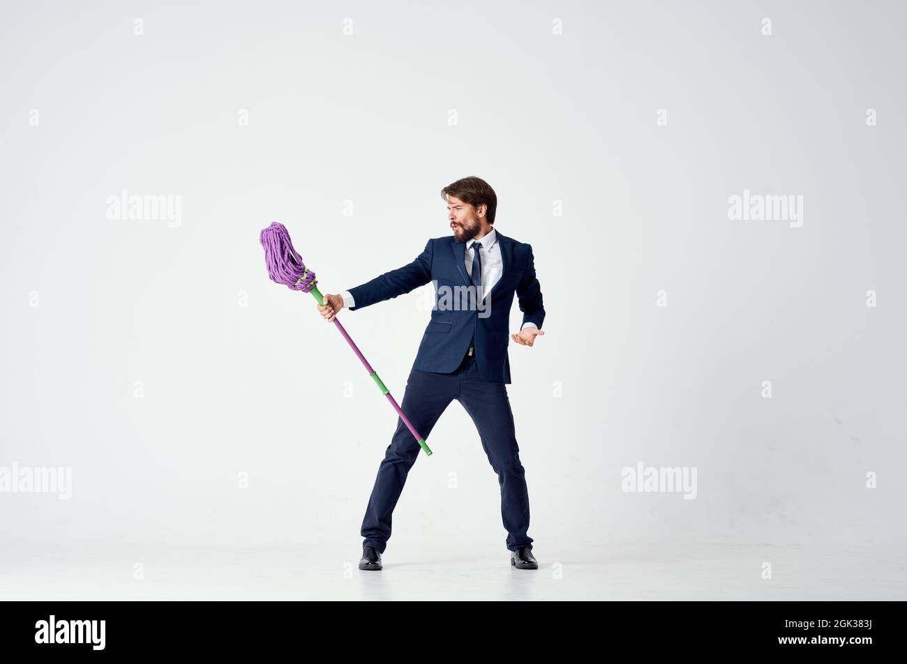 business man in a suit manager work cleaning with a mop Stock Photo - Alamy