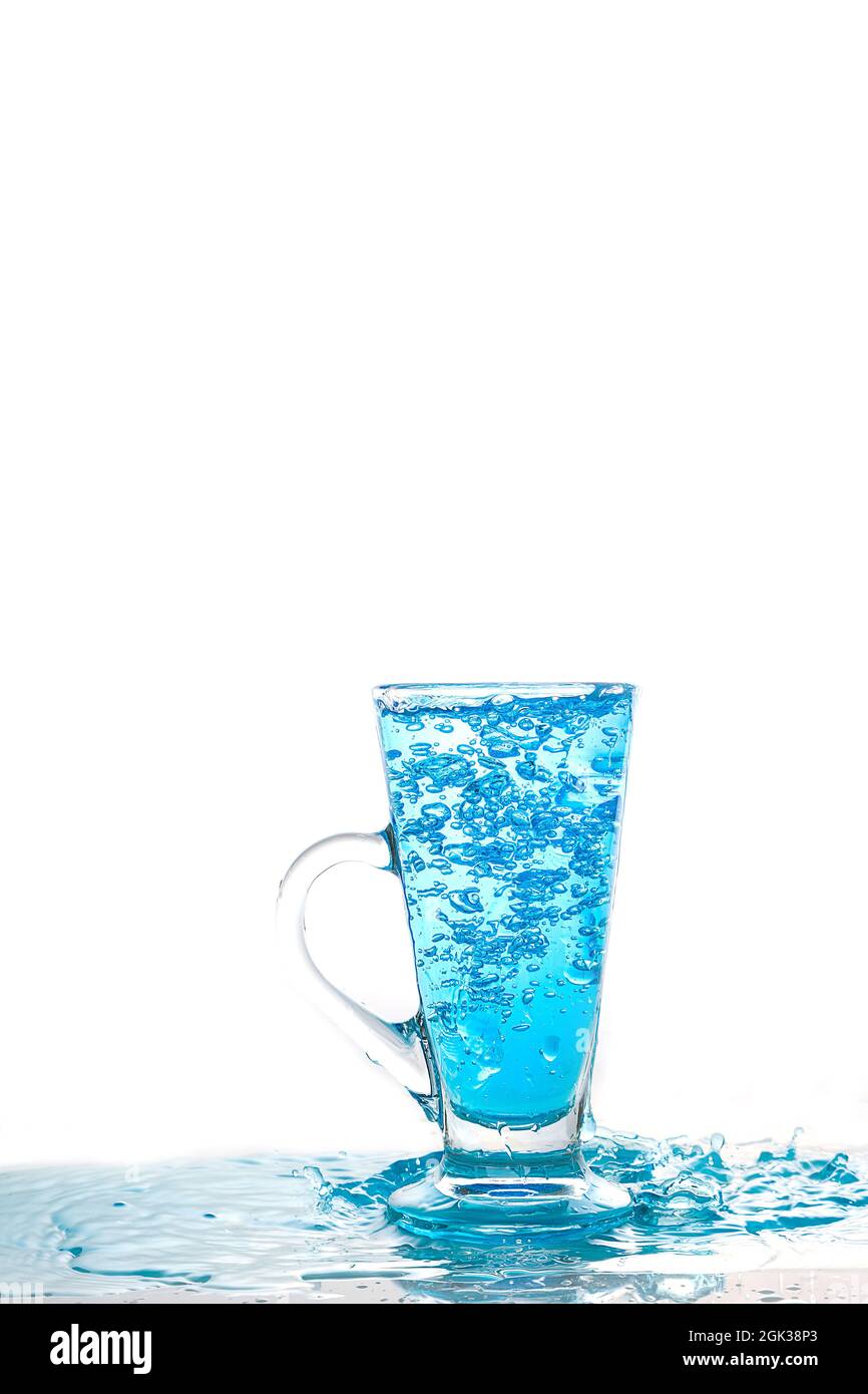 Water splashing into glass of water on white background Stock Photo - Alamy