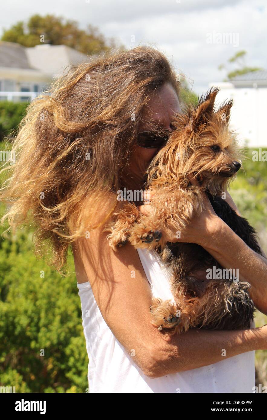Senior lady with beautiful long hair and sunglasses holding her ...