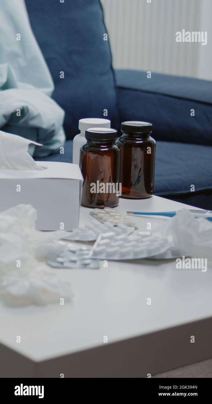 Close up of coffee table with medicine and bottle of pills. Nobody in ...