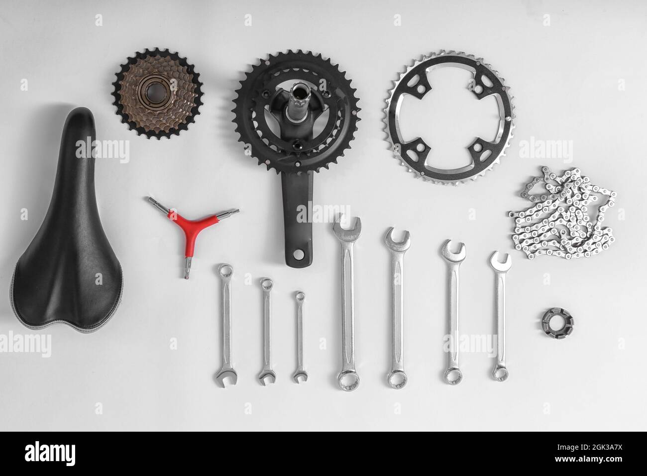 Bicycle parts and repair tools on white background Stock Photo - Alamy