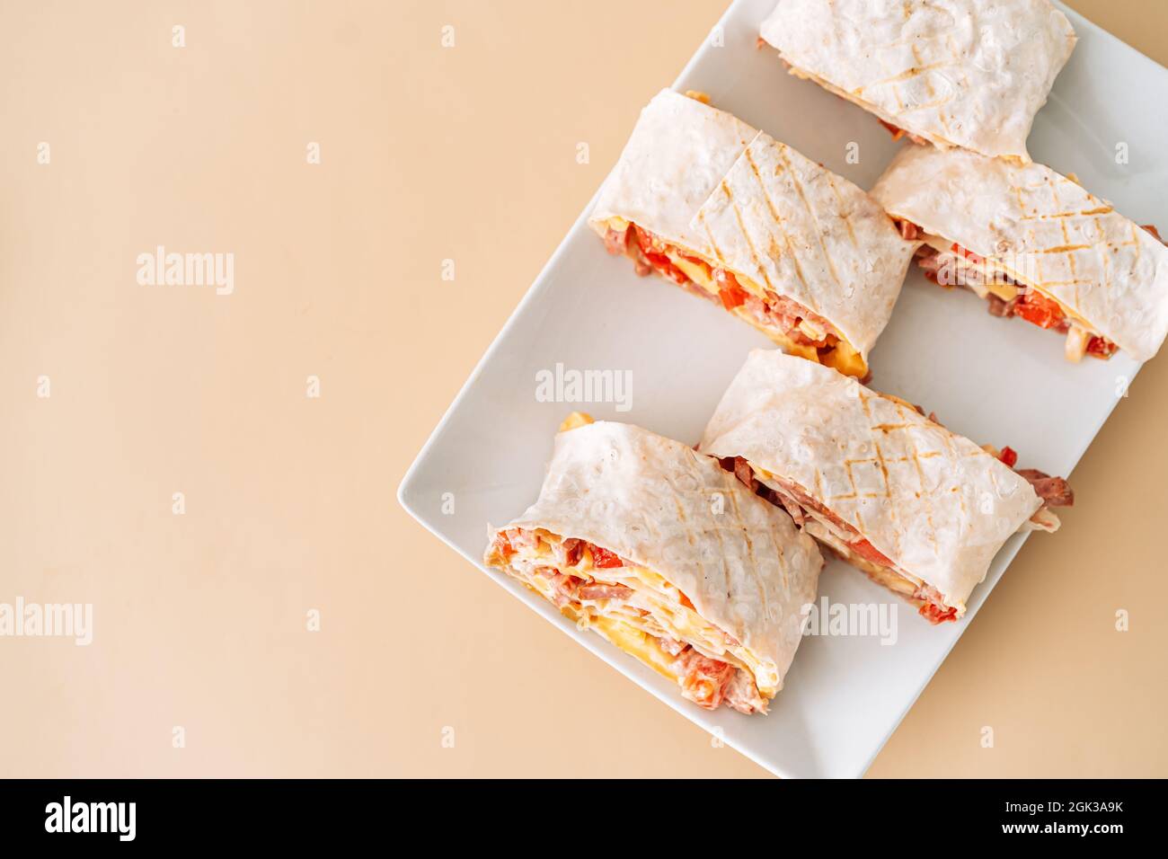 Shawarma cut into five pieces on white square plate Stock Photo - Alamy