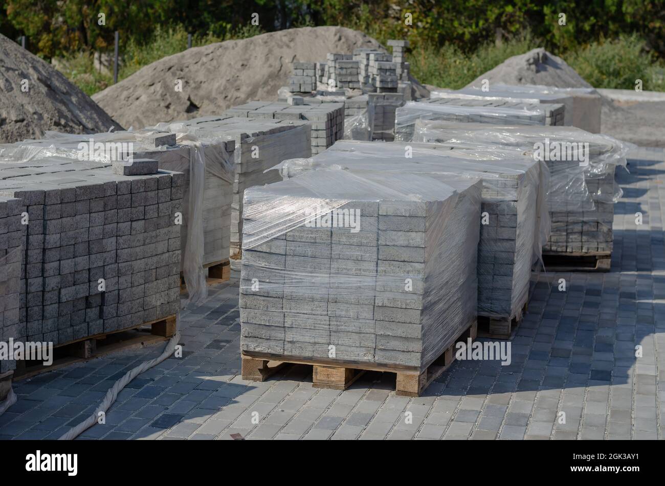 Pallets of gray paving tiles at the construction site. New cemen Stock ...