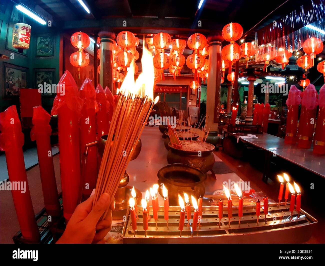 Burning incense in the shrine Wishing for good luck, in a shrine with ...