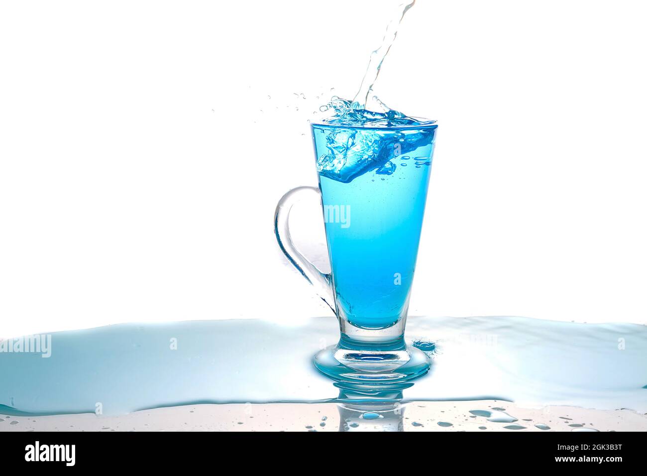 Water splashing into glass of water on white background Stock Photo - Alamy