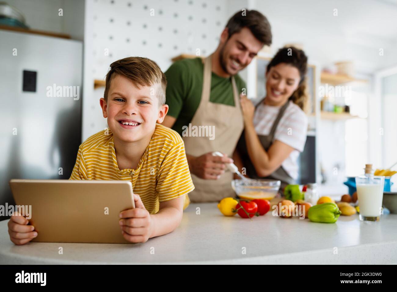 Happy family in the kitchen having fun and cooking together. Healthy ...