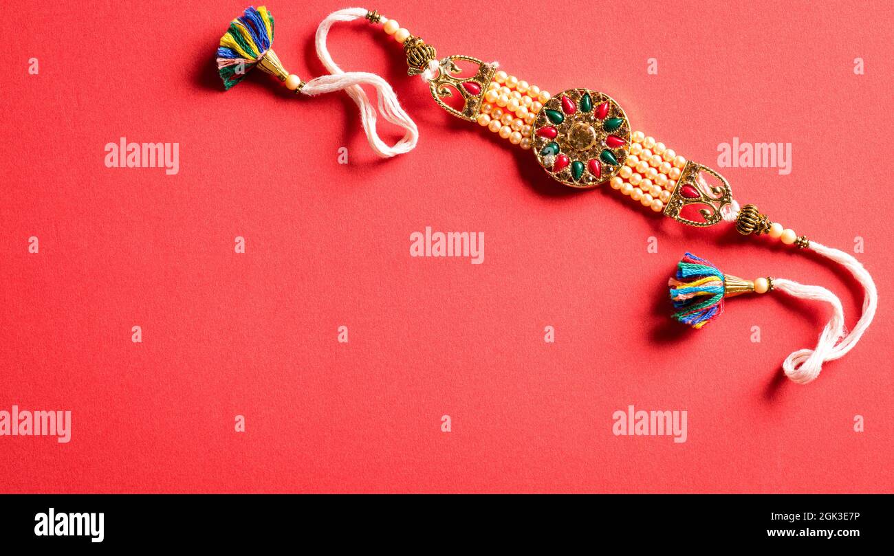 Raksha Bandhan, Indian festival with beautiful Rakhi on red background ...