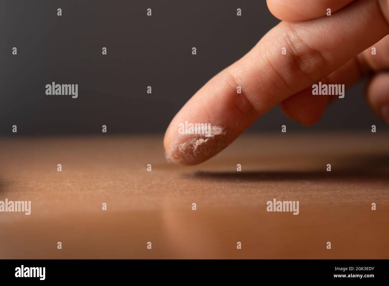Touching the dust on a surface of furniture with finger Stock Photo - Alamy