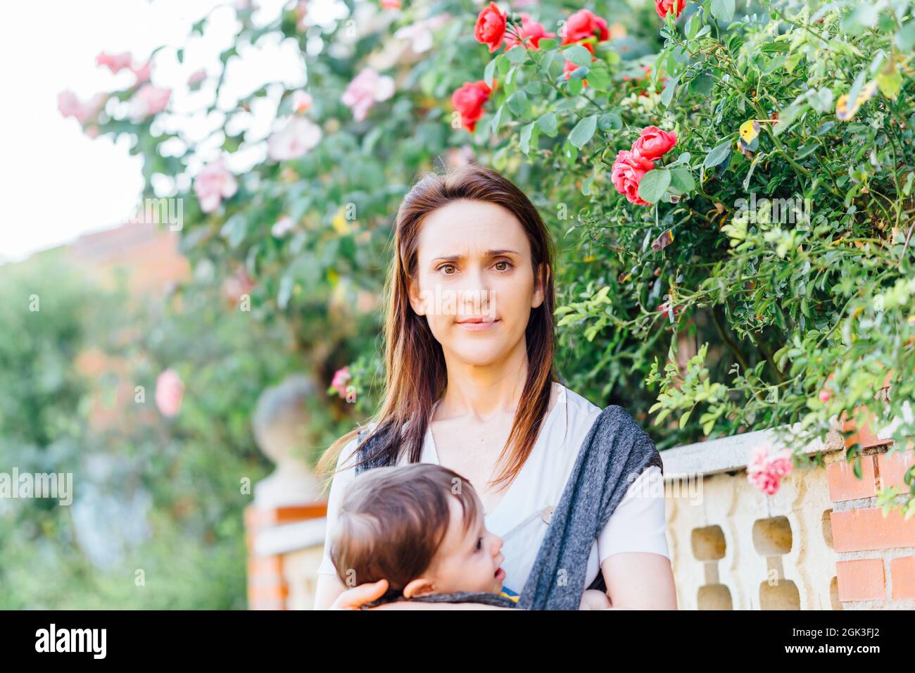 pretty smiling millennial mother holding her one year old baby Stock ...