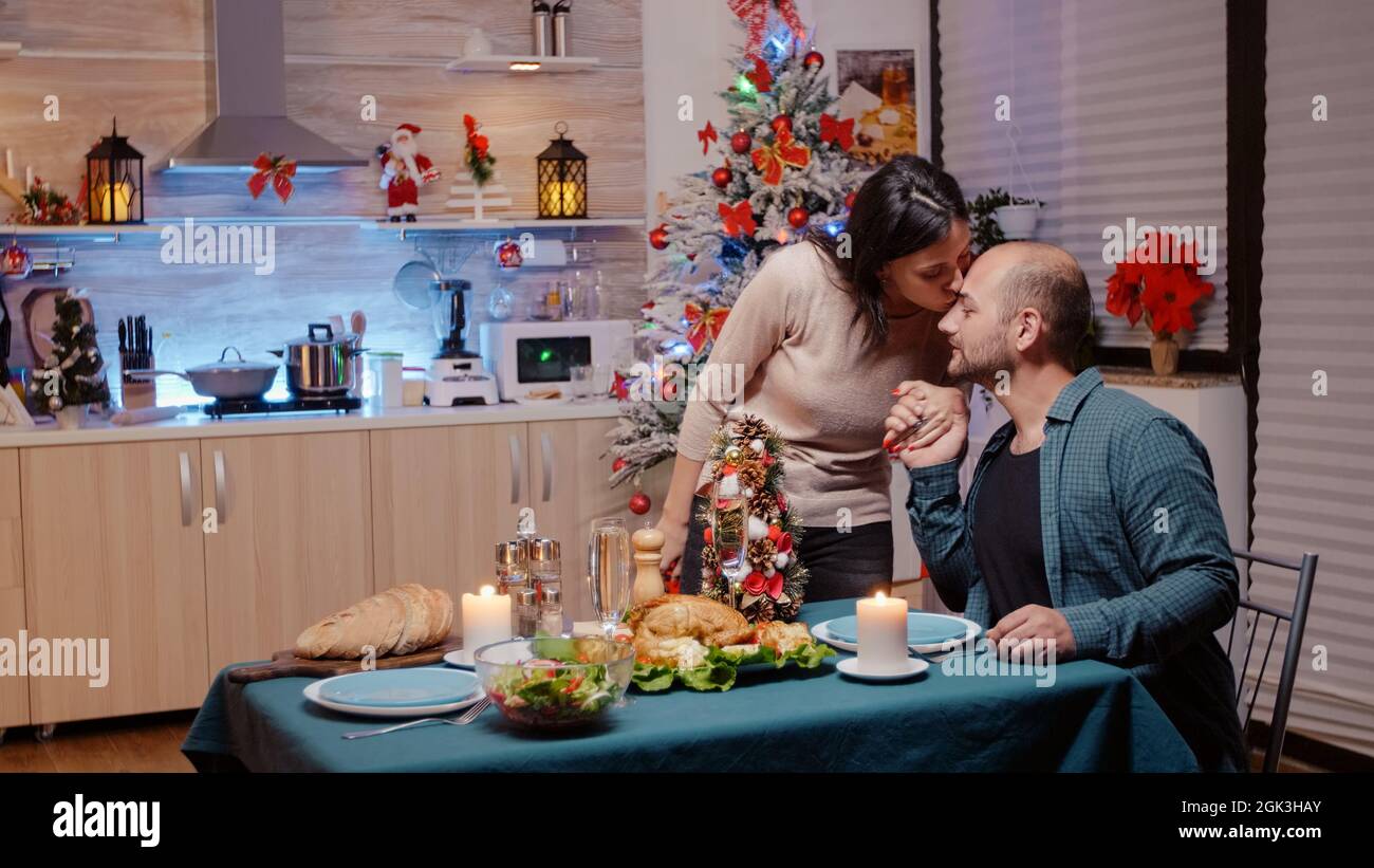 Woman preparing christmas dinner for celebration with man. Festive ...