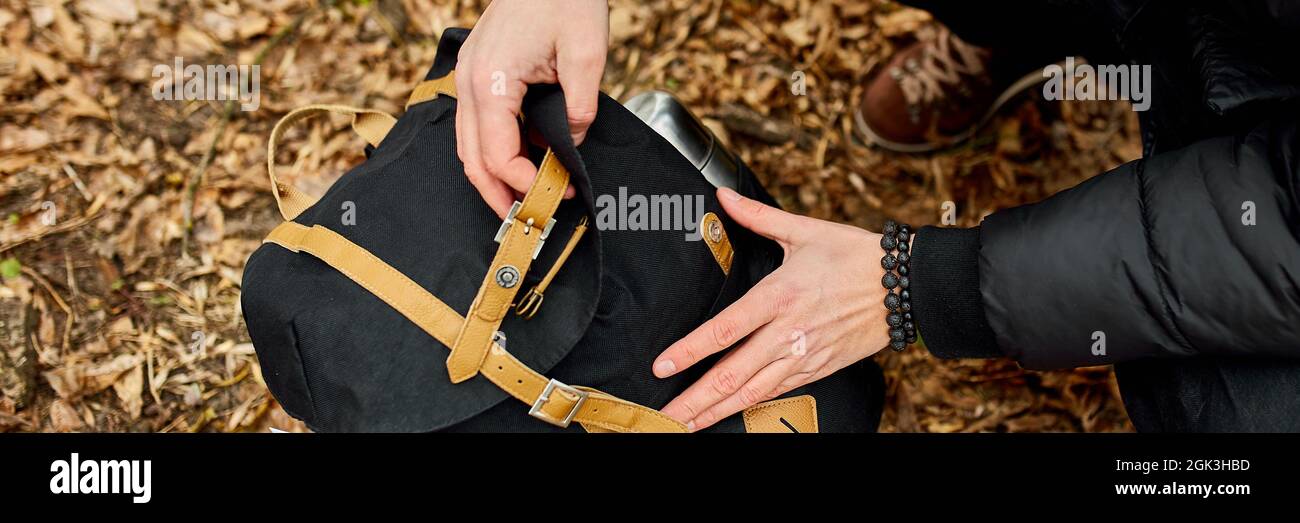 Tourist man looking into his backpack, Travel concept, Autumn ...