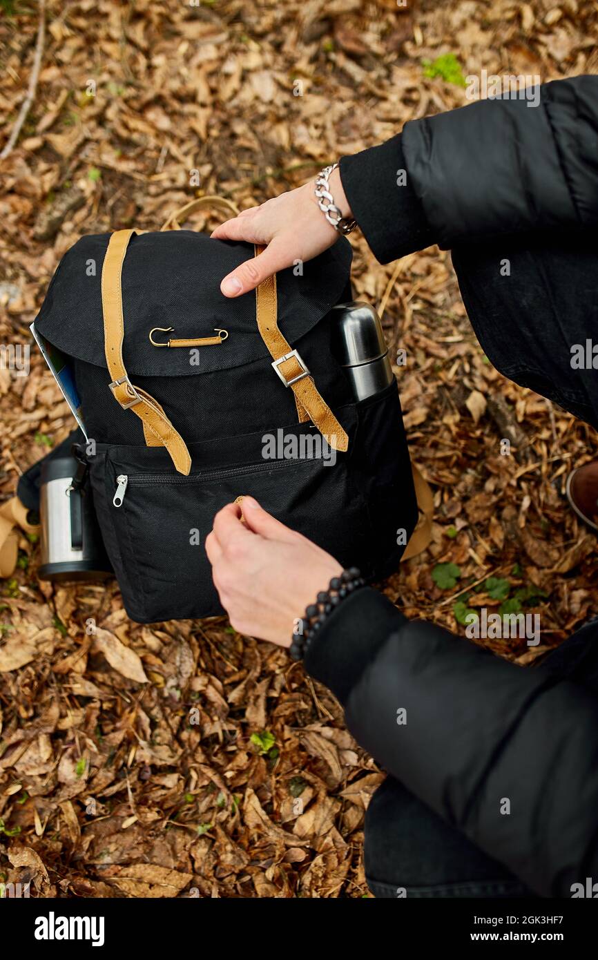 Tourist man looking into his backpack, Travel concept, Autumn ...