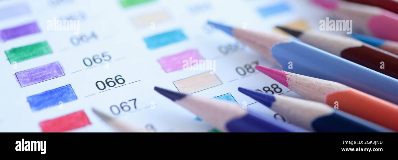 Colored pencils are on color palette with numbers Stock Photo - Alamy
