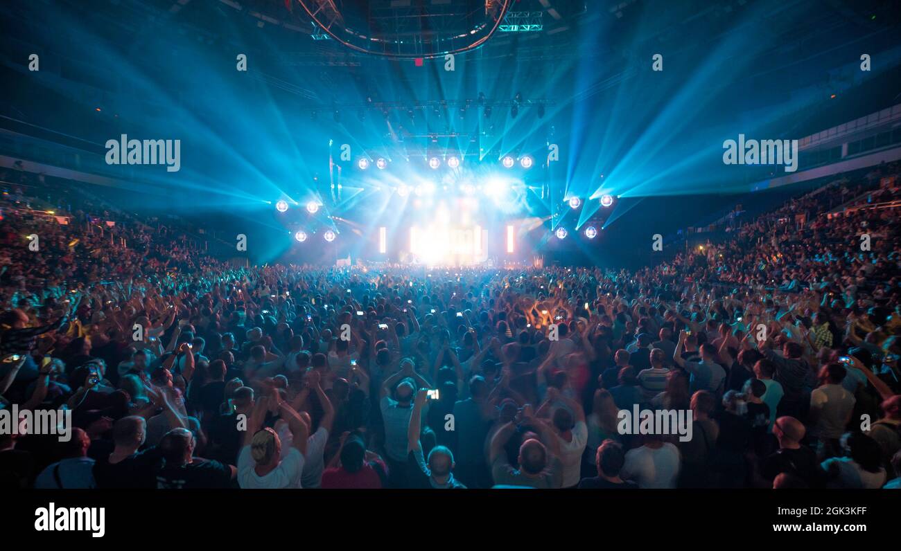 people at a concert are filming an artist's performance on a smartphone ...